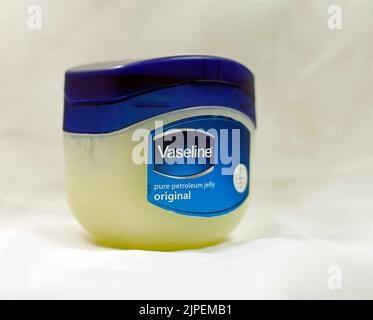 Vaseline petroleum jelly. Plastic tub / container with blue lid against ...