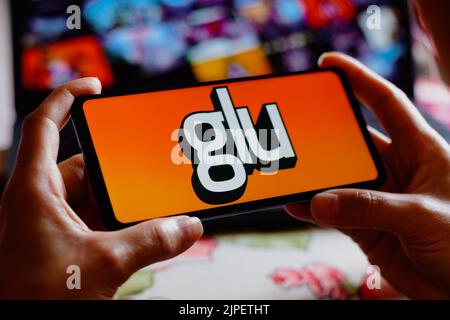 In this photo illustration, the Glu Mobile logo is displayed on a ...