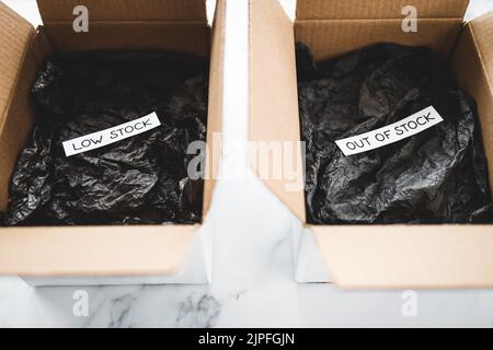 Low stock and out of stock texts inside of empty delivery parcels with ...