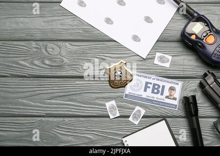 Finger prints with document of FBI agent and badge on wooden background ...