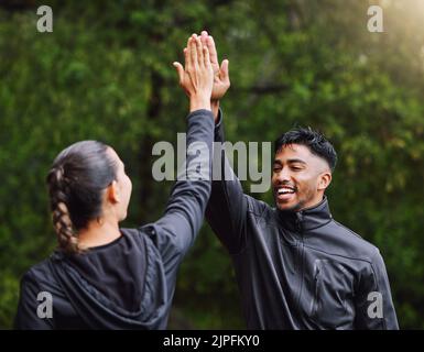 Couple of athletes doing high five Stock Photo - Alamy