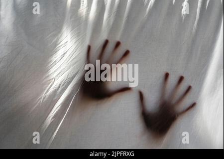 Hands shade behind sheet Stock Photo - Alamy