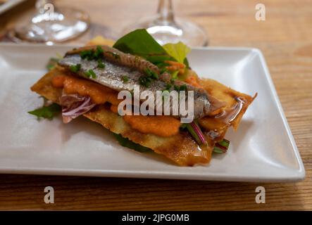 Spanish food, one tapas small piece of roasted bread cracker with ...