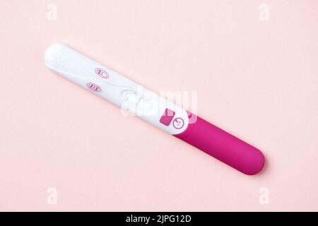 Positive pregnancy test on pink background Stock Photo - Alamy