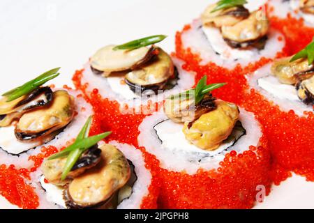 Elite sushi on a white background in red tobiko caviar with mussels on ...
