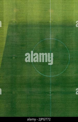A top view of the football pitch with people playing in it on a sunny ...