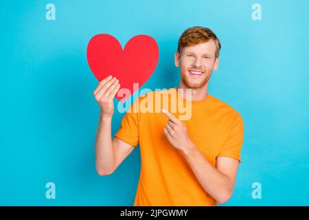Photo of romantic guy toothy smile show love heart symbol wear purple t ...