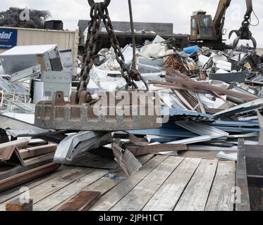A large Caterpillar track material handler with an attached magnet ...