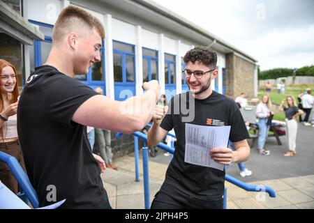 Gower College Swansea student Josh Lewis (right) opens his results at ...
