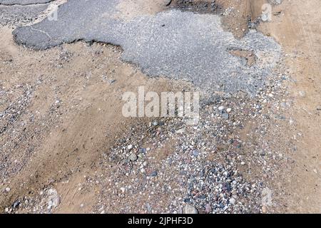 the place of transition from an asphalt road to a dirt road, poor ...