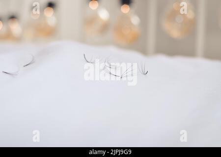 Bunches of fake lashes fell down after eyelash extensions, beauty salon ...