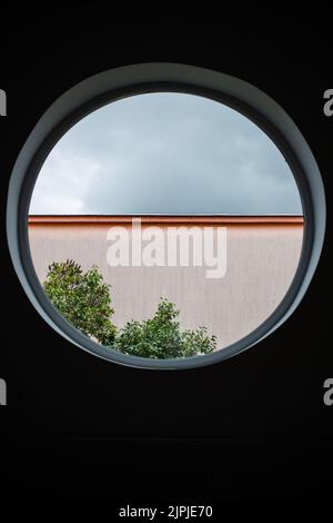 Round window tree and house Stock Photo - Alamy