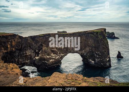 A fantastic coastal view of arch rock made of lava rock Stock Photo - Alamy