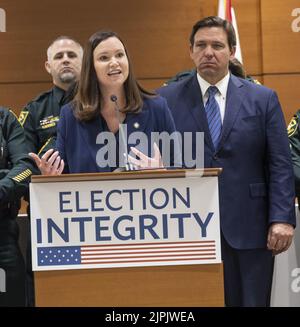 Florida Attorney General Ashley Moody, right, is sworn in by her father ...