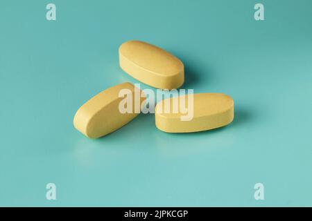 White caplet on blue caplets background Stock Photo - Alamy