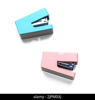 Two colorful staplers on white background Stock Photo - Alamy