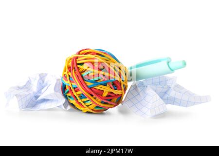 Colorful rubber band ball, crumpled paper and pen on white background ...