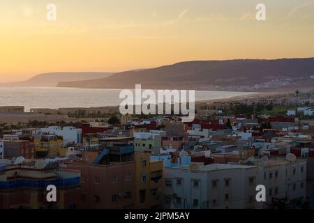 An aerial view of village Tamraght surrounded by buildings and water ...