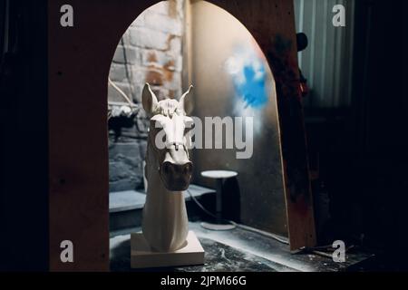 Artisan craftsman create horse based on plaster cast. Gypsum mold and ...