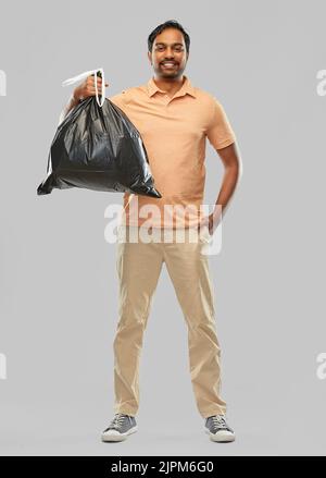 smiling indian man holding trash bag Stock Photo - Alamy
