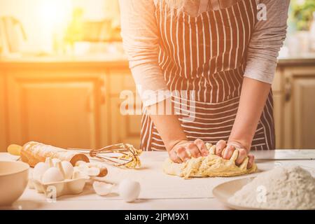 Woman hands kneading dough on kitchen table Stock Photo - Alamy