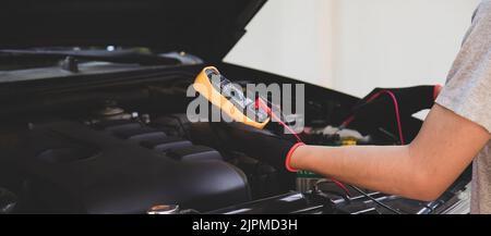 Mechanic checking the car's electrics with a multimeter Stock Photo - Alamy