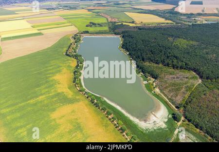 a small artificial lake built against floods in the downstream towns ...