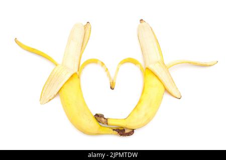 Two half-peeled bananas isolated on a white background. One banana hugs ...