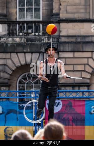 Street performer juggler with swords ball and hoop performing for ...