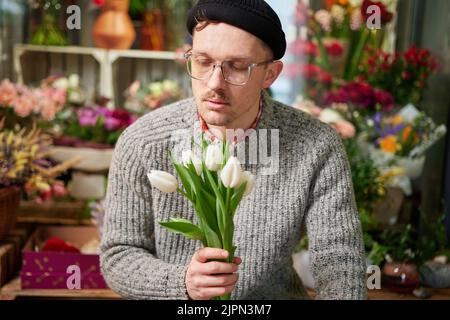 Flower for March 8. Bearded man with tulip flower bouquet. Love date ...