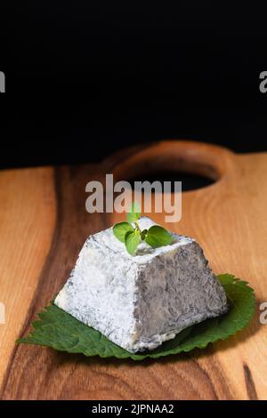 Food concept organic Valencay cheese PDO pyramid shape on wooden board ...