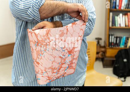 Artist Tugay Yalcin teaches beginners the art of paper marbling, a ...