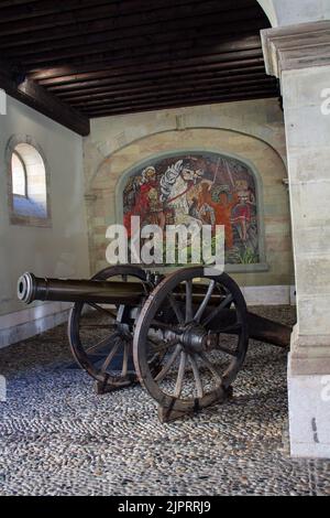 A vertical shot of a cannon weapon in a castle under the blue sky Stock ...