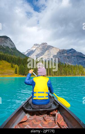 Kayaking in a glacier lake during a vibrant sunny summer day. Taken in ...
