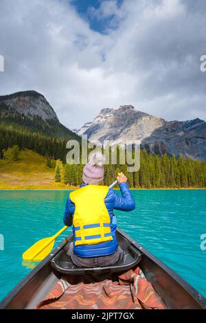 Kayaking in a glacier lake during a vibrant sunny summer day. Taken in ...