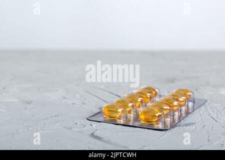 Blister package with fish oil capsules on color background. Medicine ...
