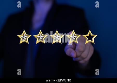 The person's hand pointing at hovering stars. Rating, evaluation Stock ...