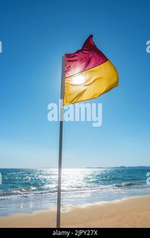 Swim between the flags on a sunny beach Stock Photo - Alamy
