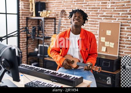 African american man playing ukelele at music studio Stock Photo - Alamy