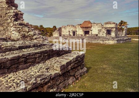 Ruins of Mayan building immersed in a green meadow: View of some parts ...