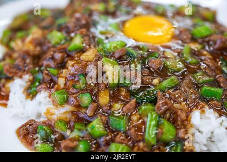 A plate of delicious and tempting nest egg minced beef rice in a Hong ...