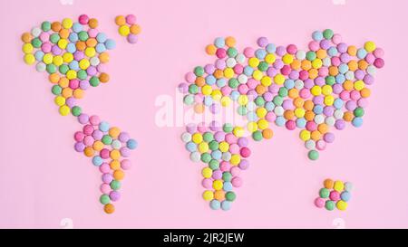 World map made with colorful candies on pastel blue bakcgorund. Flat ...