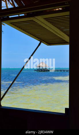 A view of the beach from inside a palapa hut at a beach resort on ...