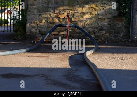 Fire hydrant with 2 hoses attached & being used to supply water to ...