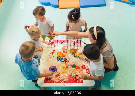 kids playing with kinetic sand at the nursery. High quality photo Stock ...