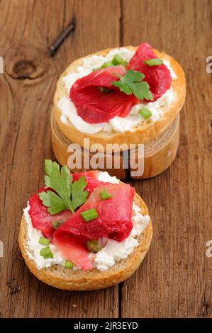 Sandwiches with gravlax, parsley, scallion and cream cheese on black ...
