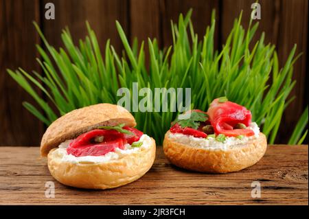 Sandwiches with gravlax, parsley, scallion and cream cheese on black ...