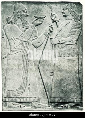 The 1910 caption reads: "Assyrian king between genie - in the Royal ...