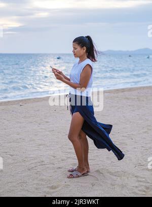 Asian women check Ethereum cryptocurrency on their phone when on ...