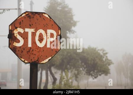 stop sign old rusty morning in the fog in the city of Dnipro drove ...